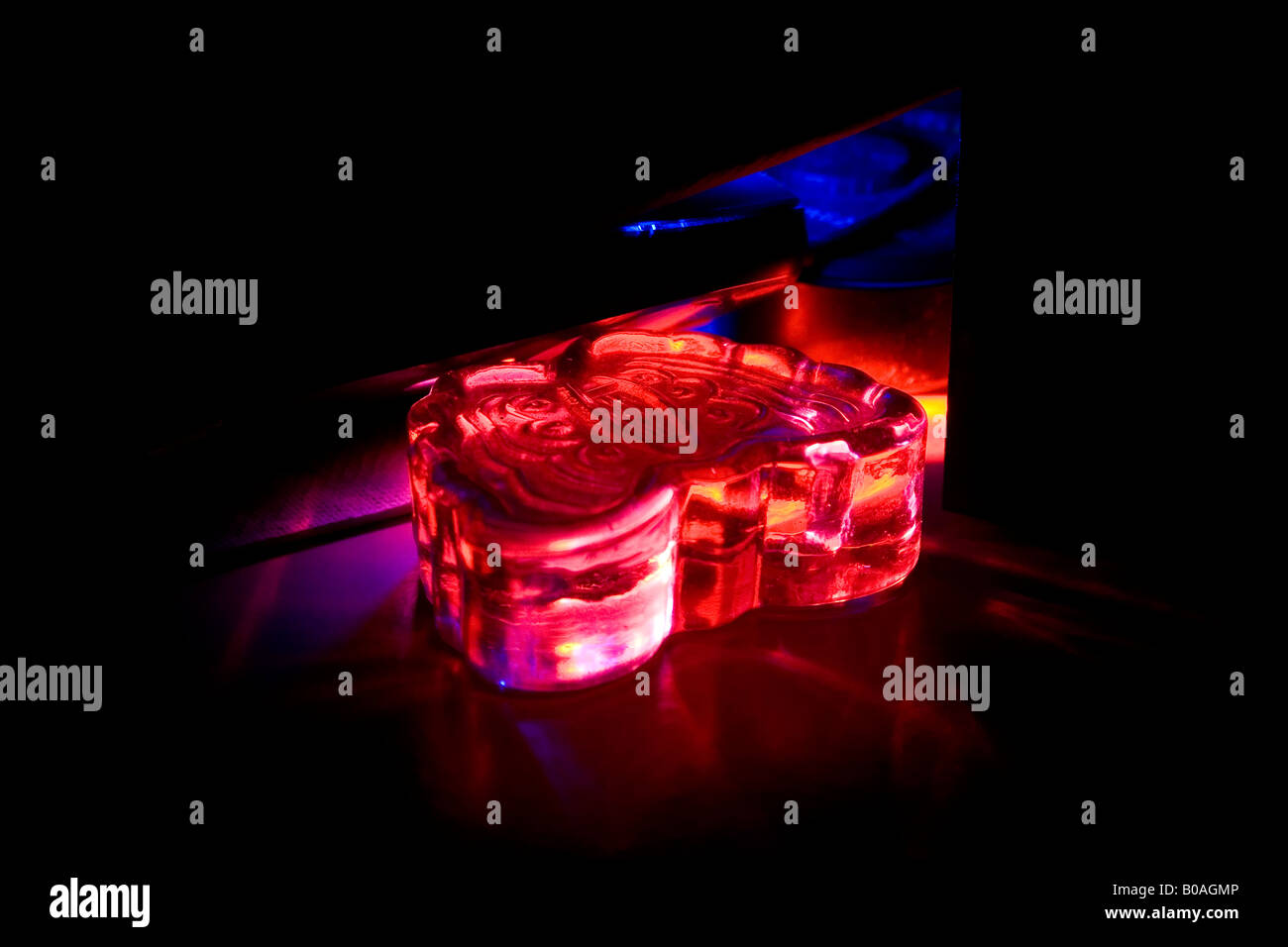 Red light through a glass sculpture Stock Photo - Alamy