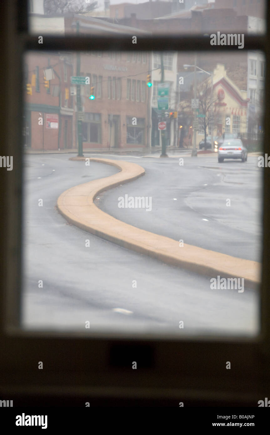 Looking out a window over a restaurant table at traffic on the street ...