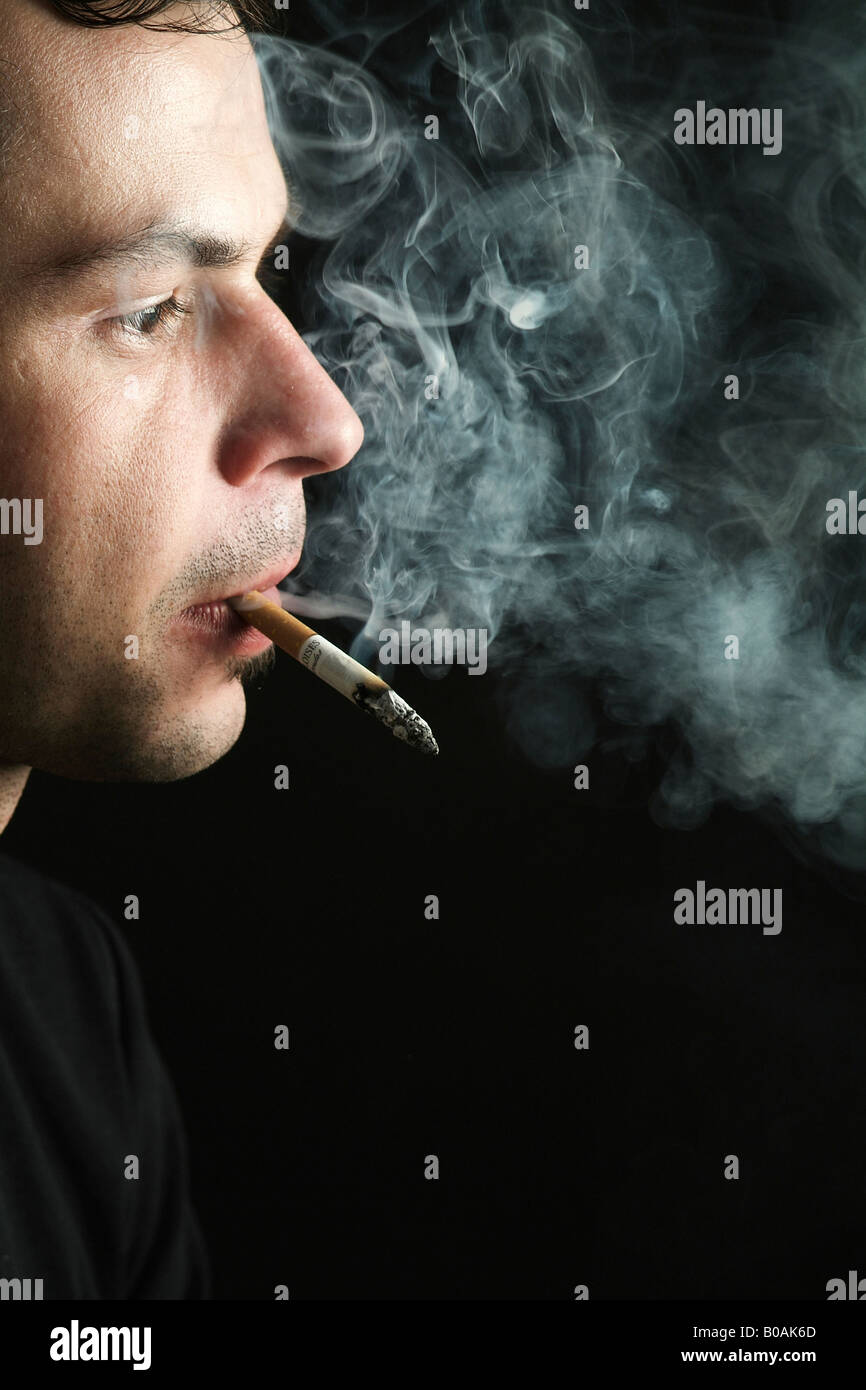 Man smoking a cigarette Stock Photo - Alamy