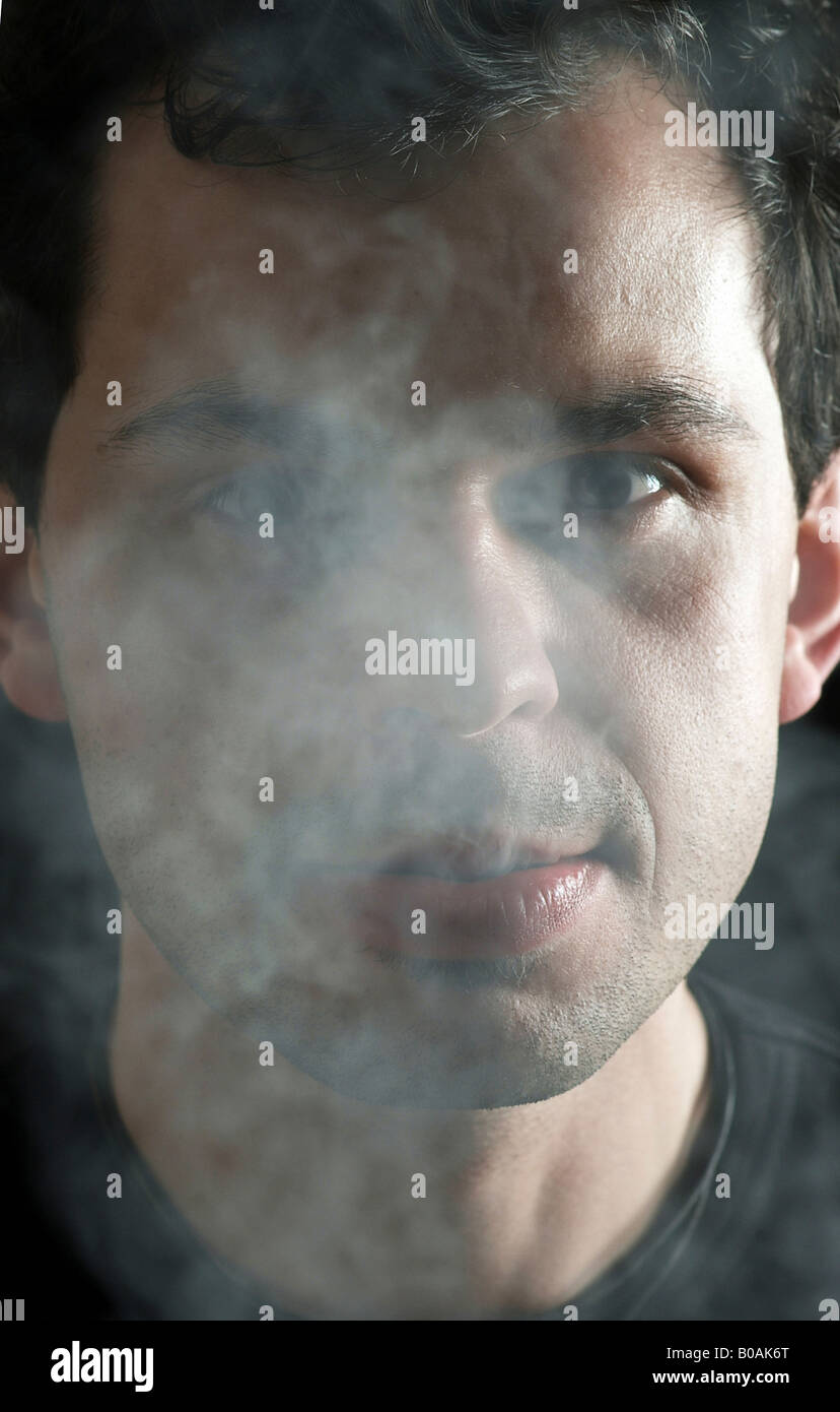 Man exhaling cigarette smoke Stock Photo - Alamy