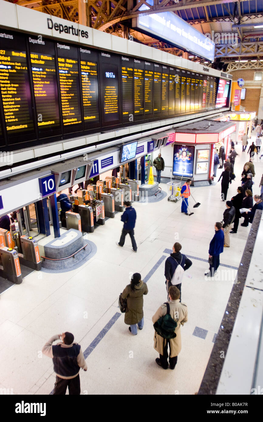 Victoria Station concourse Full of commuters looking at the boards to ...