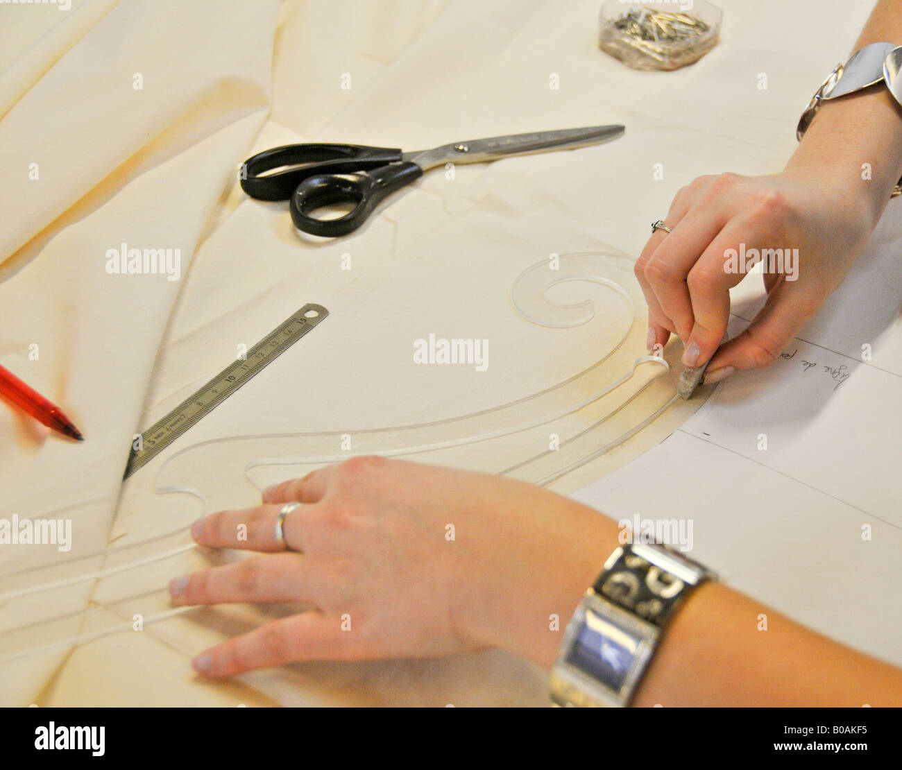 A dressmaker drawing a pattern Stock Photo - Alamy