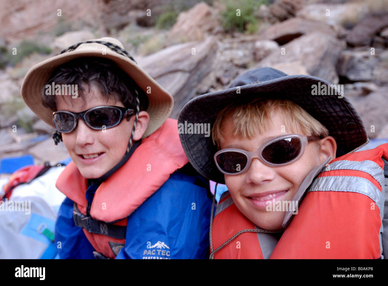 Two boys with life jackets smiling in the camera in background the ...
