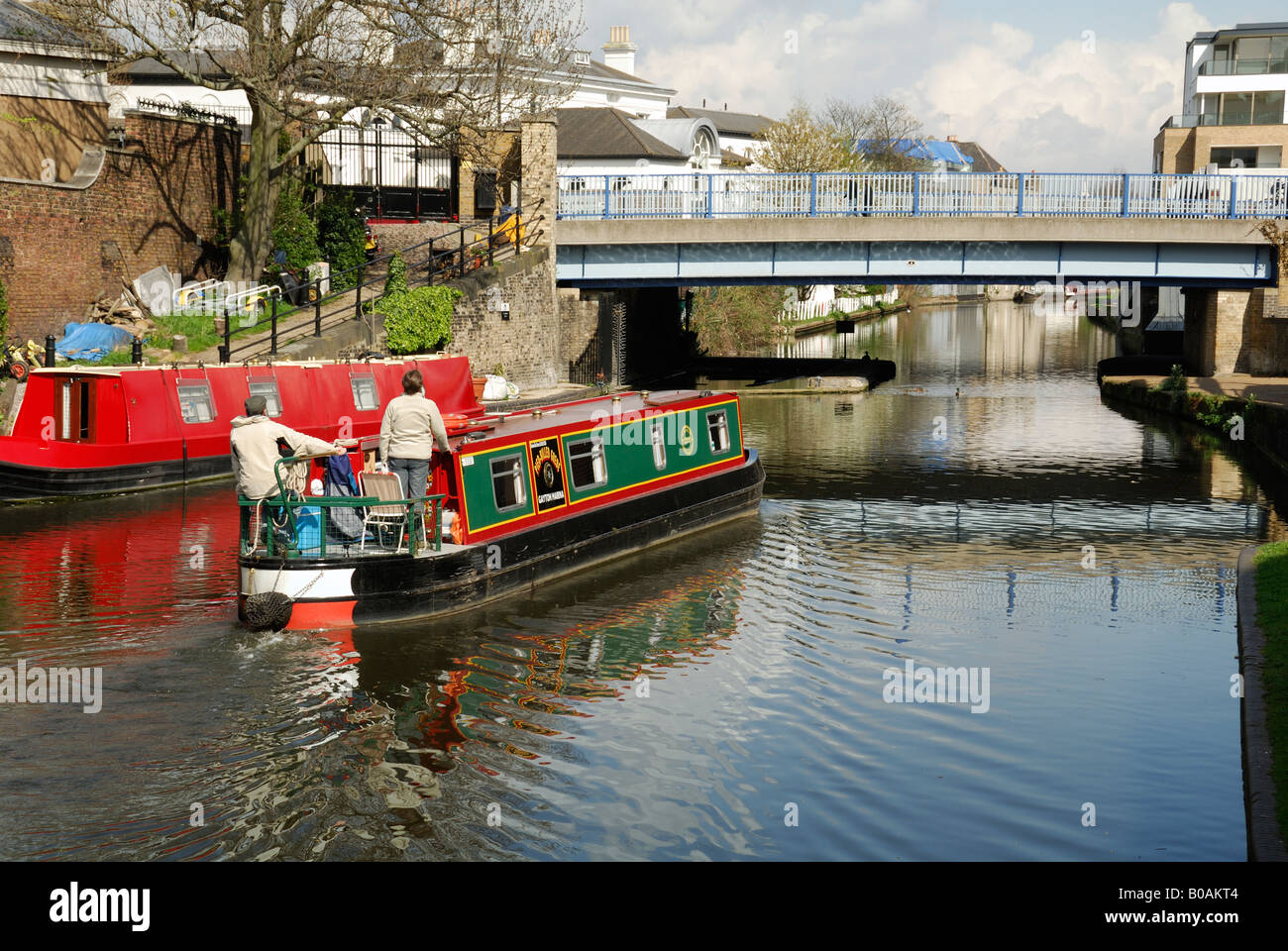 Men crossing bridge by narrow boat Stock Photo - Alamy