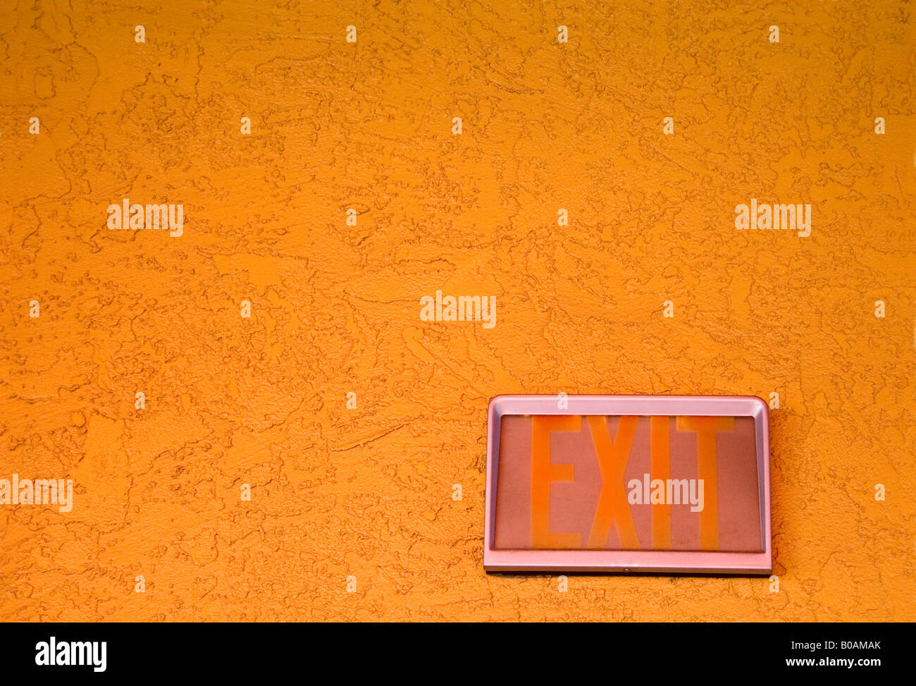 Colorful exit sign on yellow wall Stock Photo - Alamy