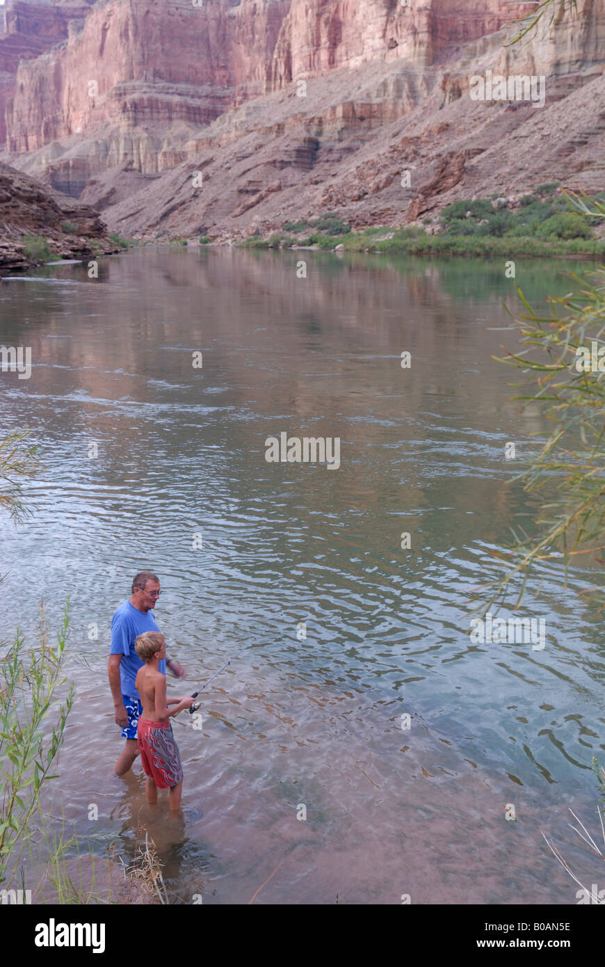 Grandfather and son fishing in the Colorado river Grand Canyon Arizona ...