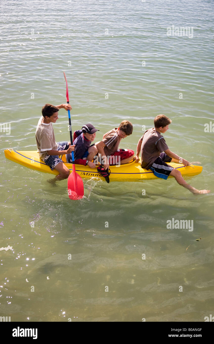 4 Kids goofing off in a kayak Stock Photo - Alamy