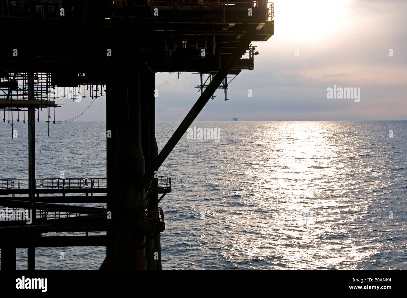 Oil rig at Sunset Stock Photo - Alamy