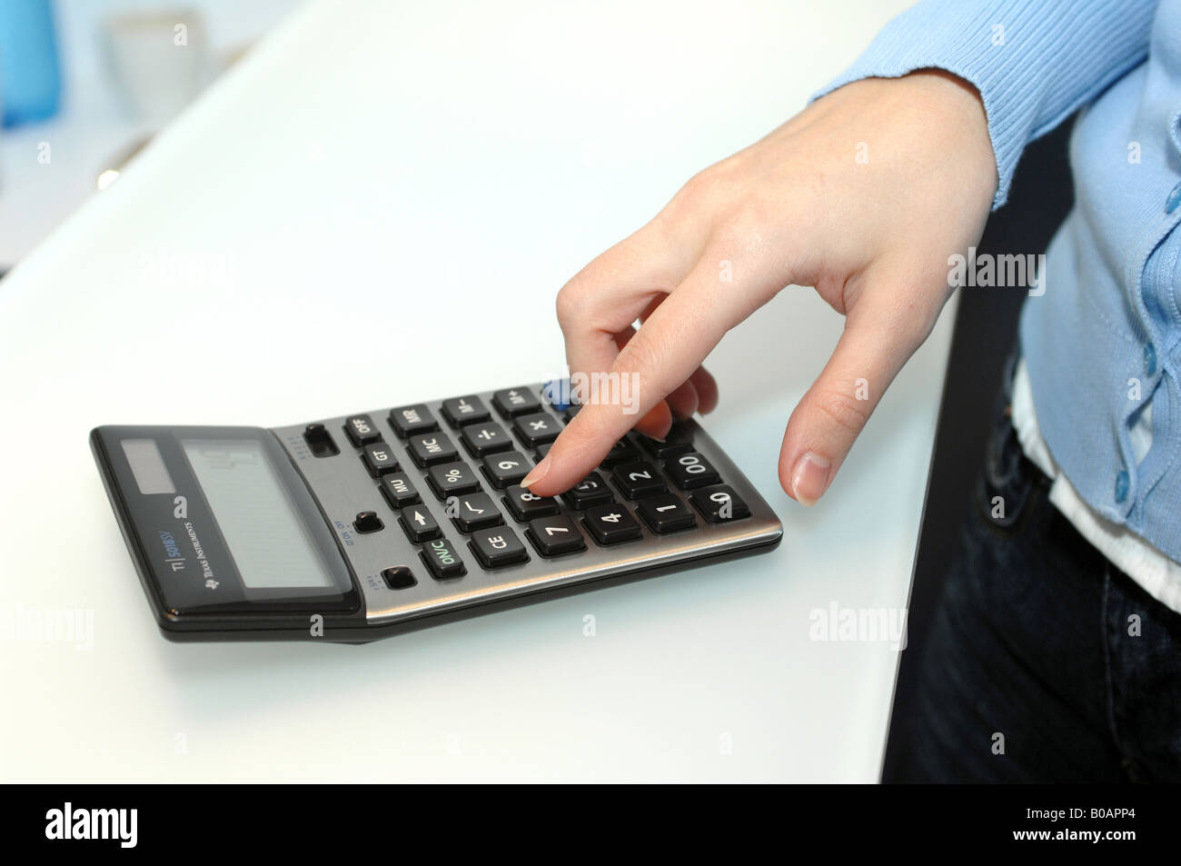 hand operating a calculator Stock Photo - Alamy