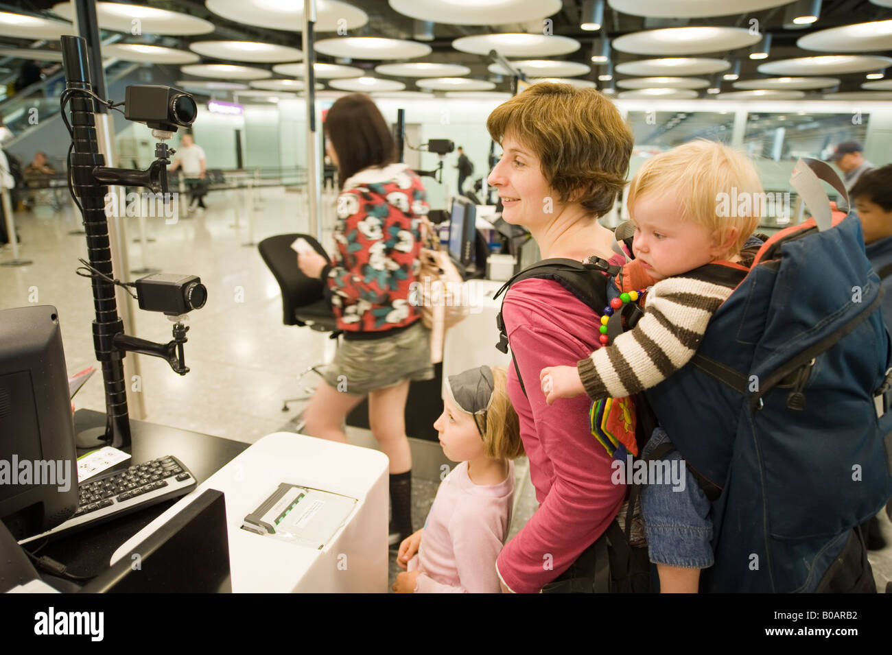 Family having their photo taken at security passport control Heathrow ...