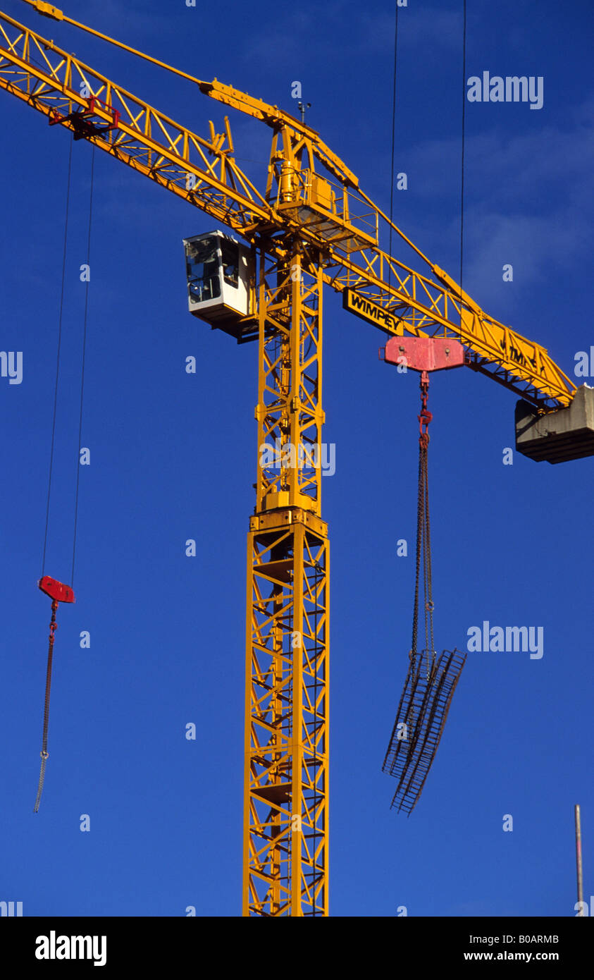 cranes and hoist carrying load on building site Leeds Yorkshire UK ...