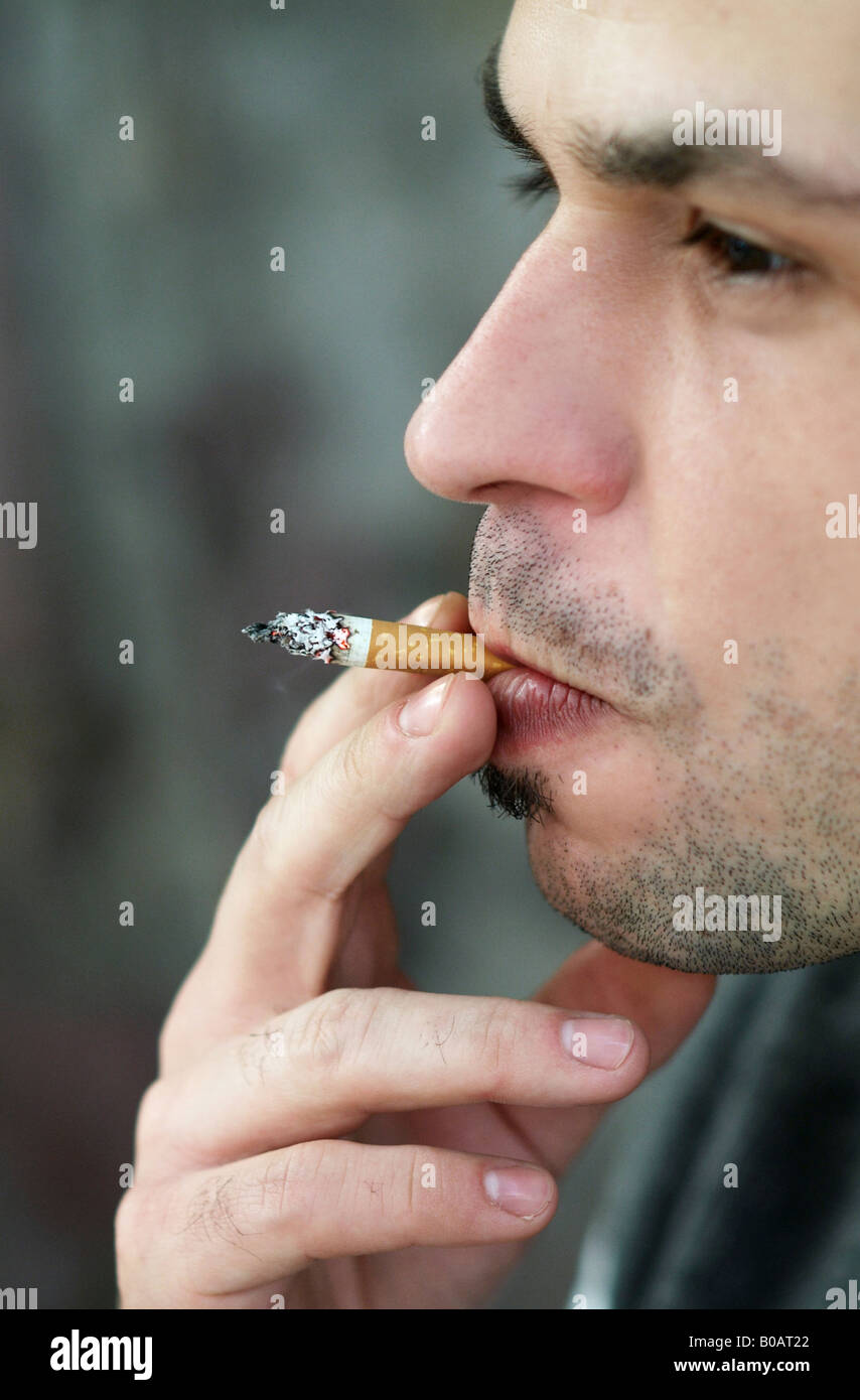 Man smoking a cigarette Stock Photo - Alamy