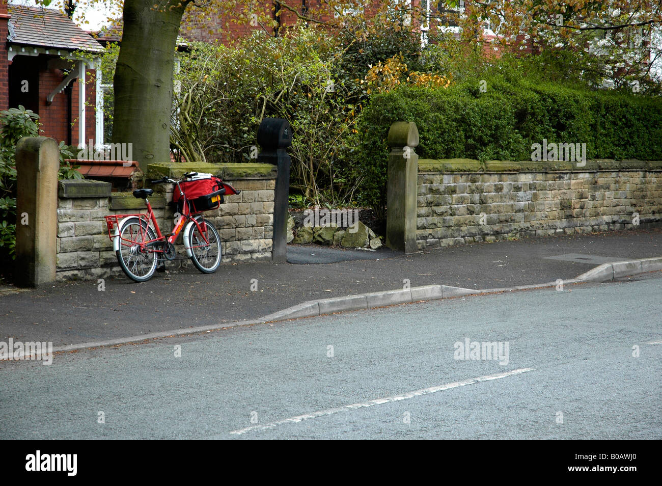 postman's cycle outside house during delivery of post Stock Photo - Alamy