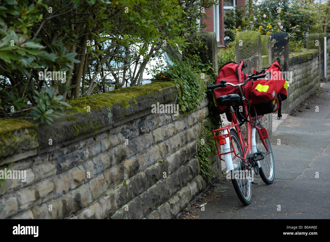 postman's cycle outside house during delivery of post Stock Photo - Alamy