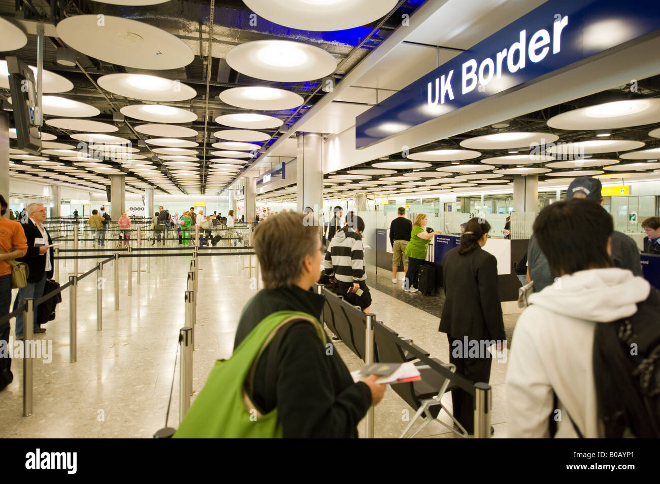 people queuing to cross the UK border at London s terminal five ...