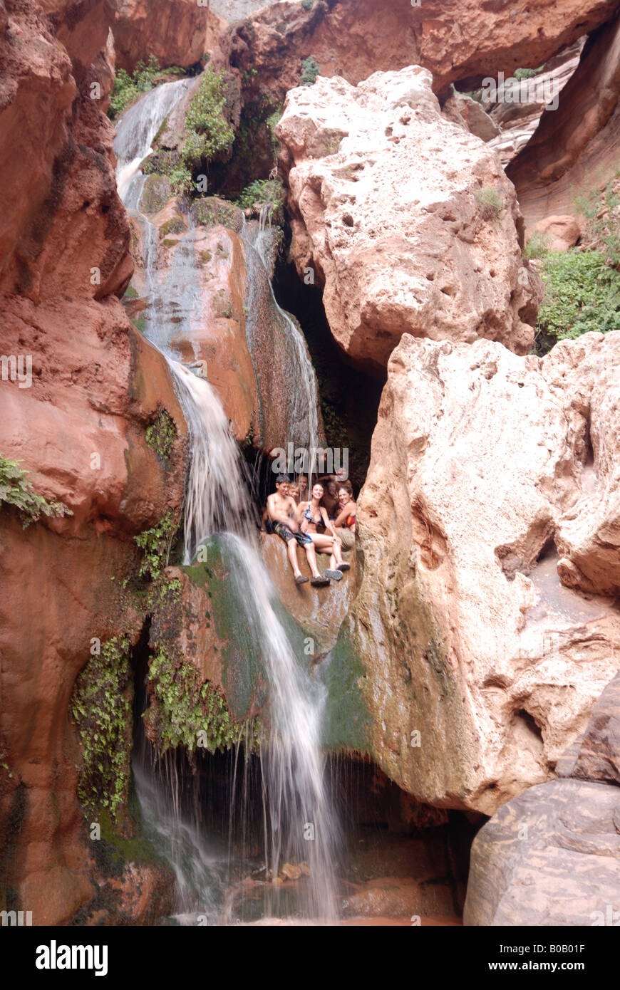 Tourist bathing in a waterfall Grand canyon seen while rafting down the ...