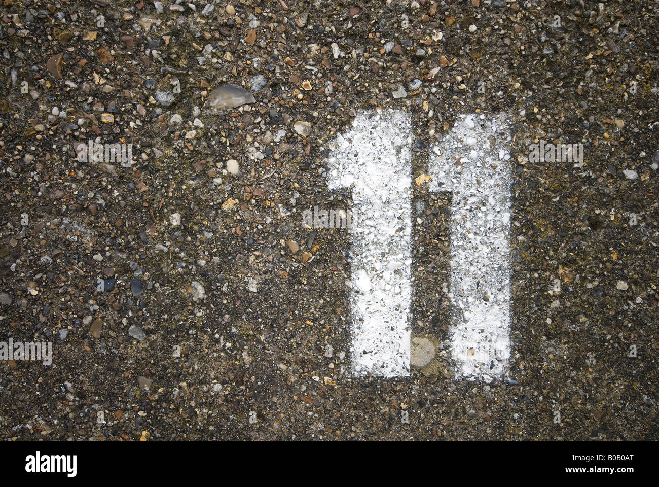 number 11 eleven painted on concrete wall Stock Photo - Alamy