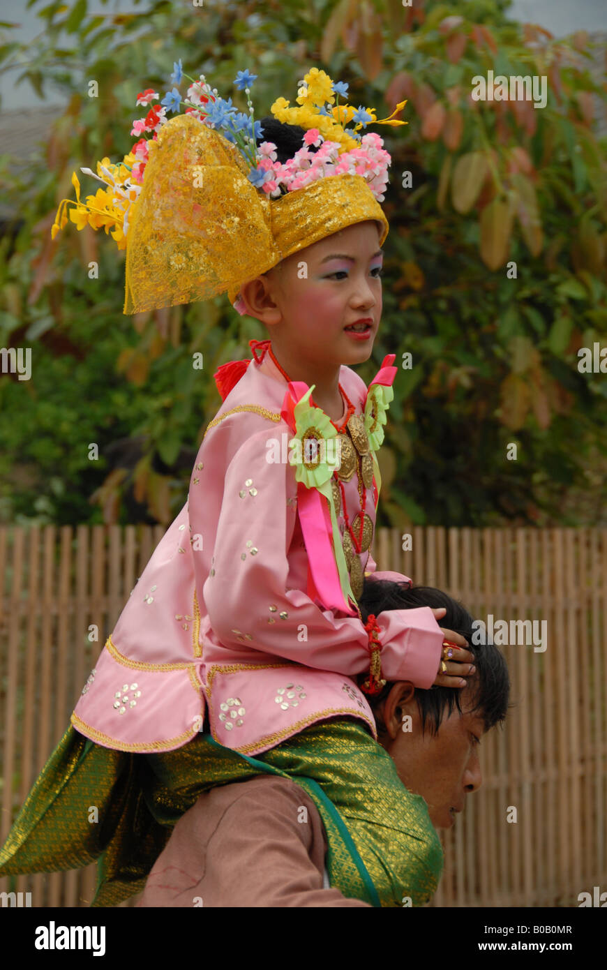 boy with beautiful dress and make up on his face,poi sang long festival ...