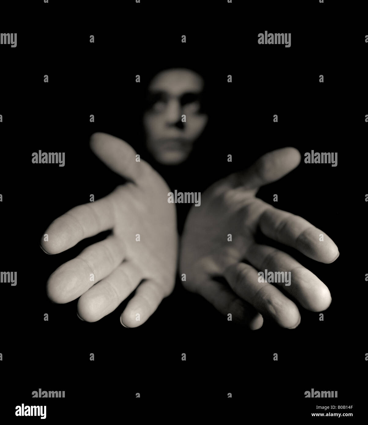 man with palms of hands out-stretched towards wide-angle Stock Photo ...