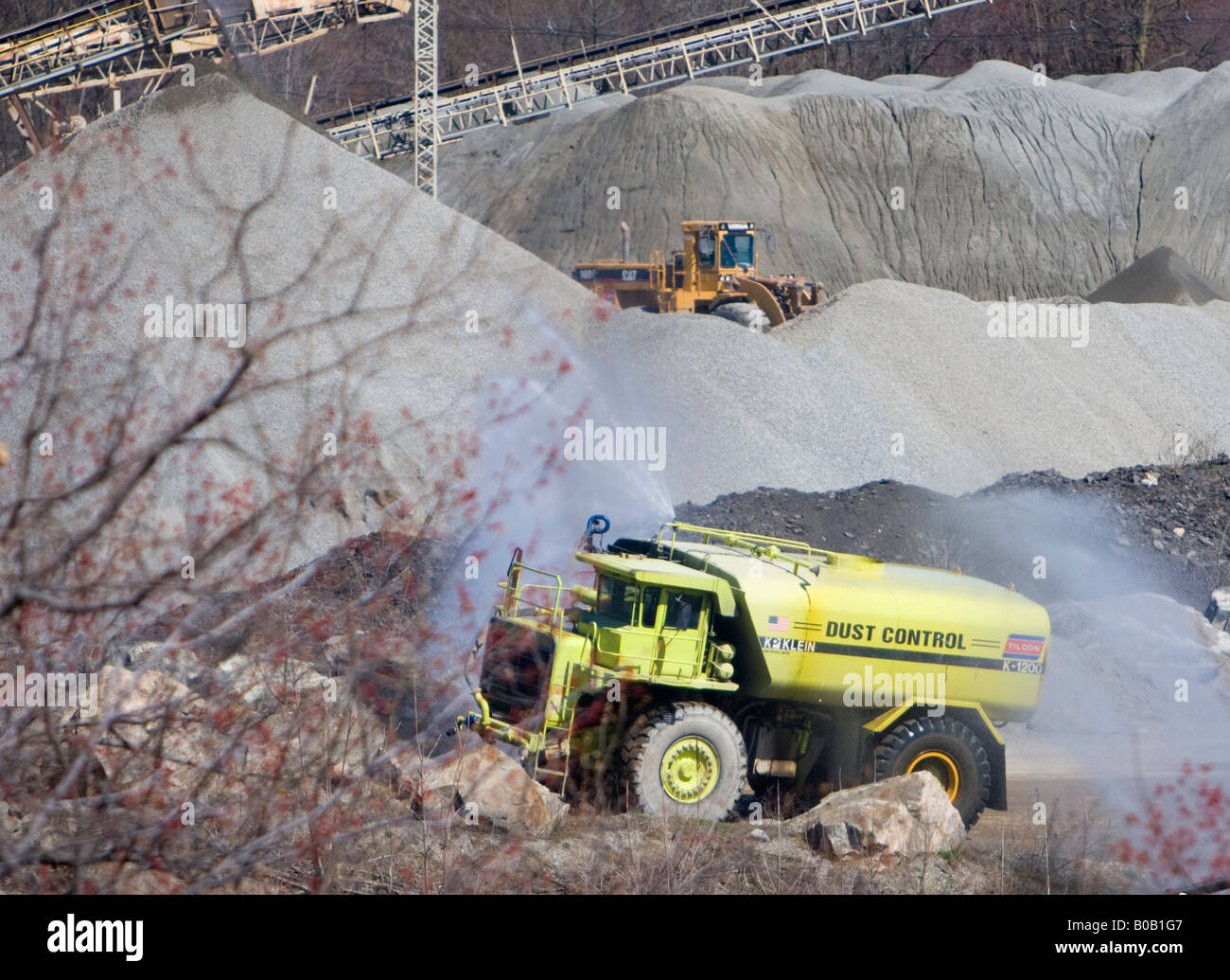 Dust control truck at a building site Stock Photo - Alamy