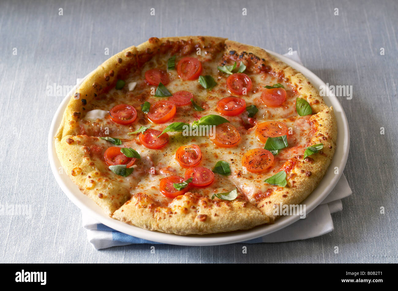 Margarita Pizza with torn basil leaves Stock Photo - Alamy