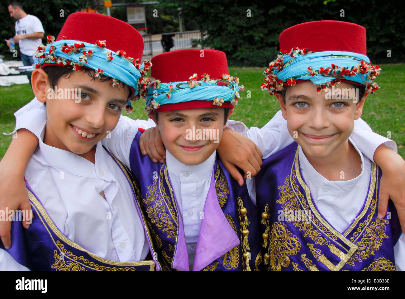 THREE YOUNG TURKISH SCHOOL CHILDREN IN FOLKLORISTIC OUTFIT DURING ...