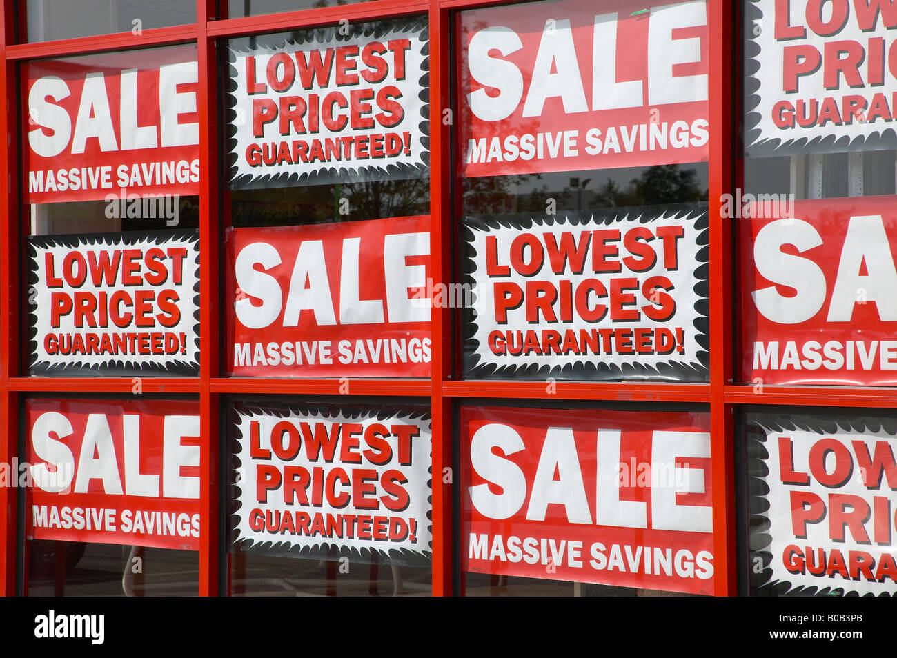 Sale signs in shop window Stock Photo - Alamy