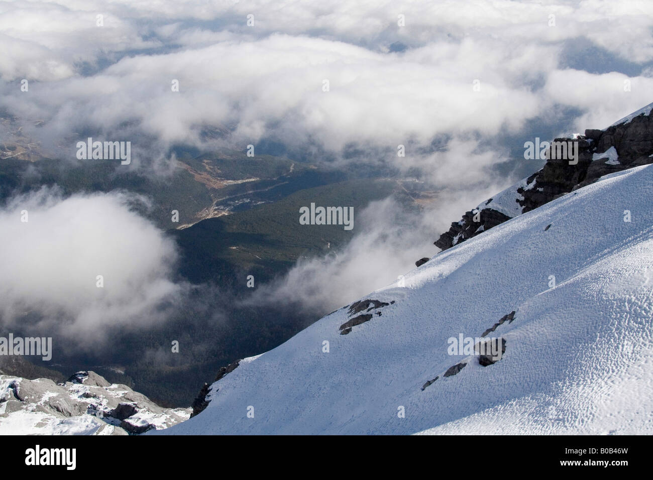 Mountain slope above the clouds at the Yulong Snow Mountain, at Lijiang ...