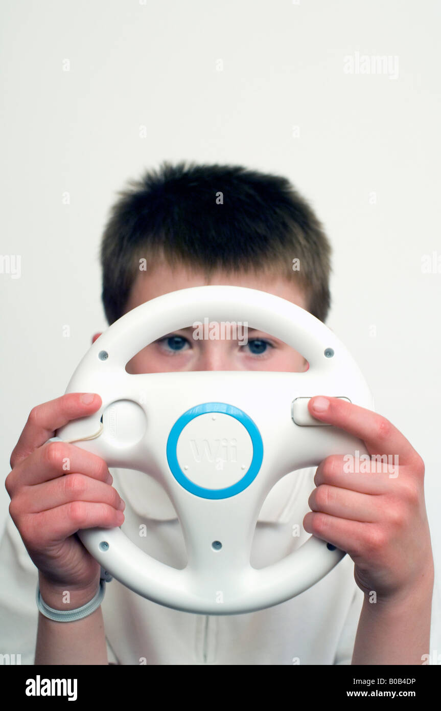 Boy Playing With Nintendo Wii Wheel Stock Photo - Alamy