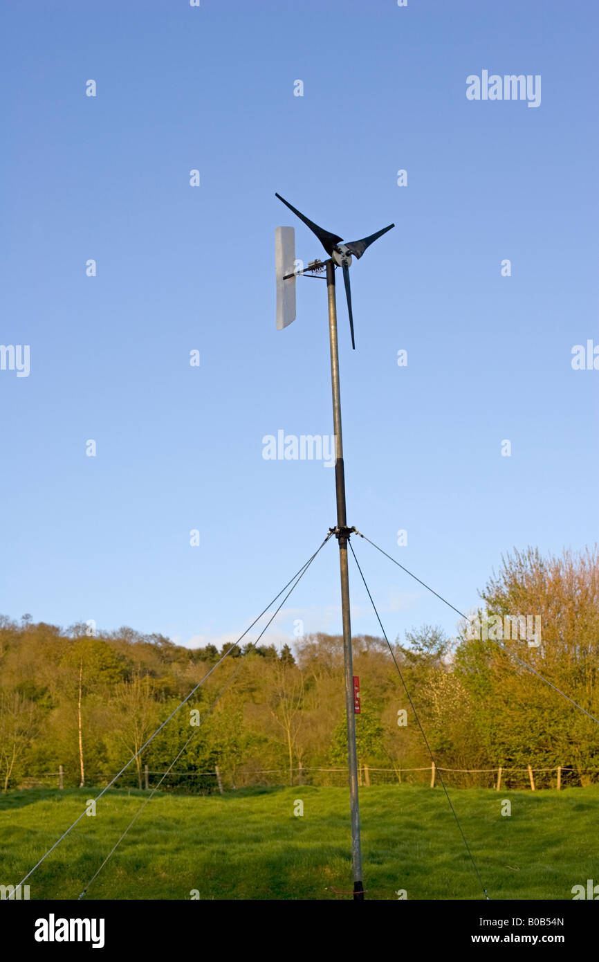Small homemade wind turbine supported by four guys in field Cotswolds ...