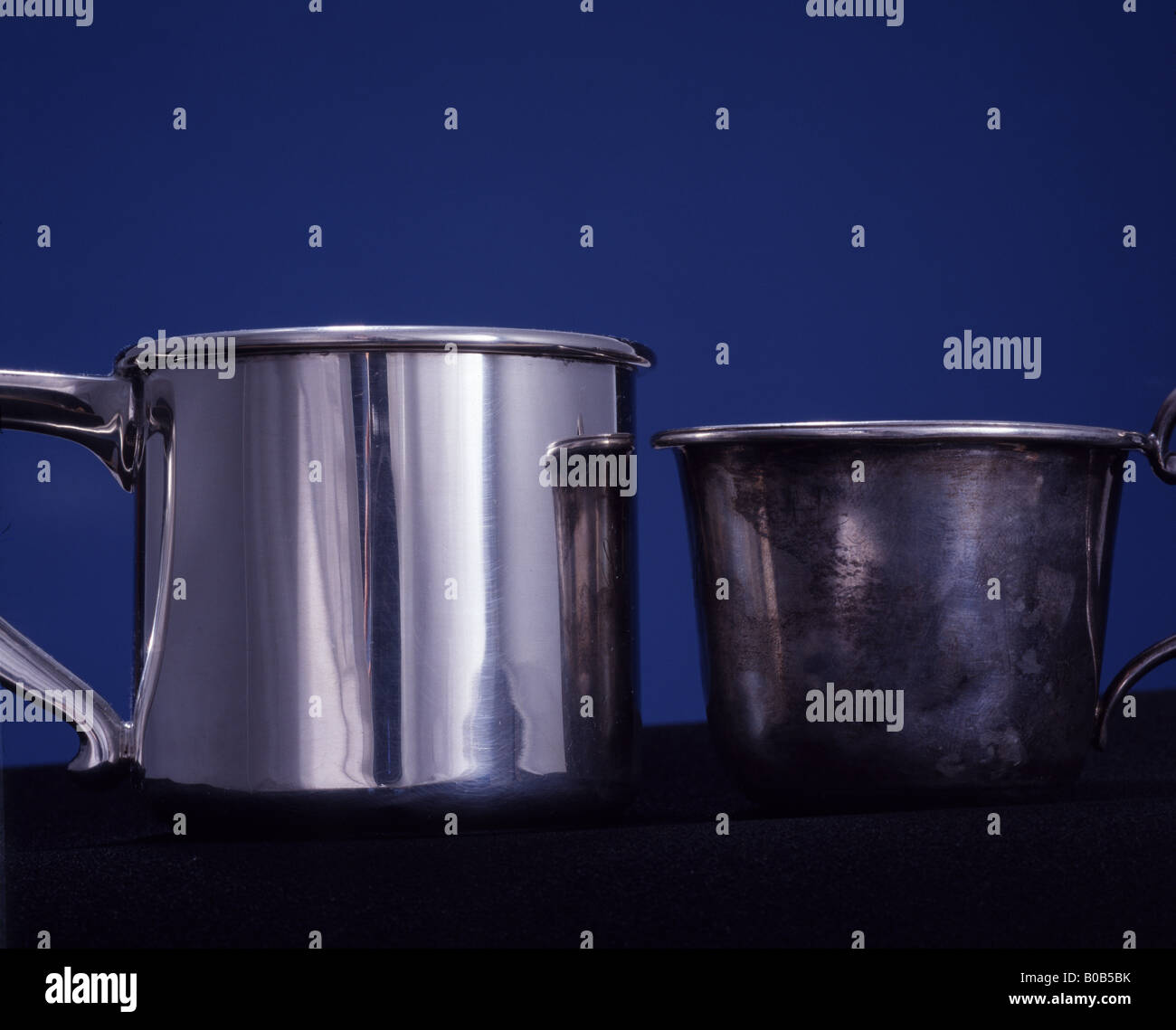 COMPARISON OF TARNISHED AND UNTARNISHED SILVER CUPS Stock Photo - Alamy