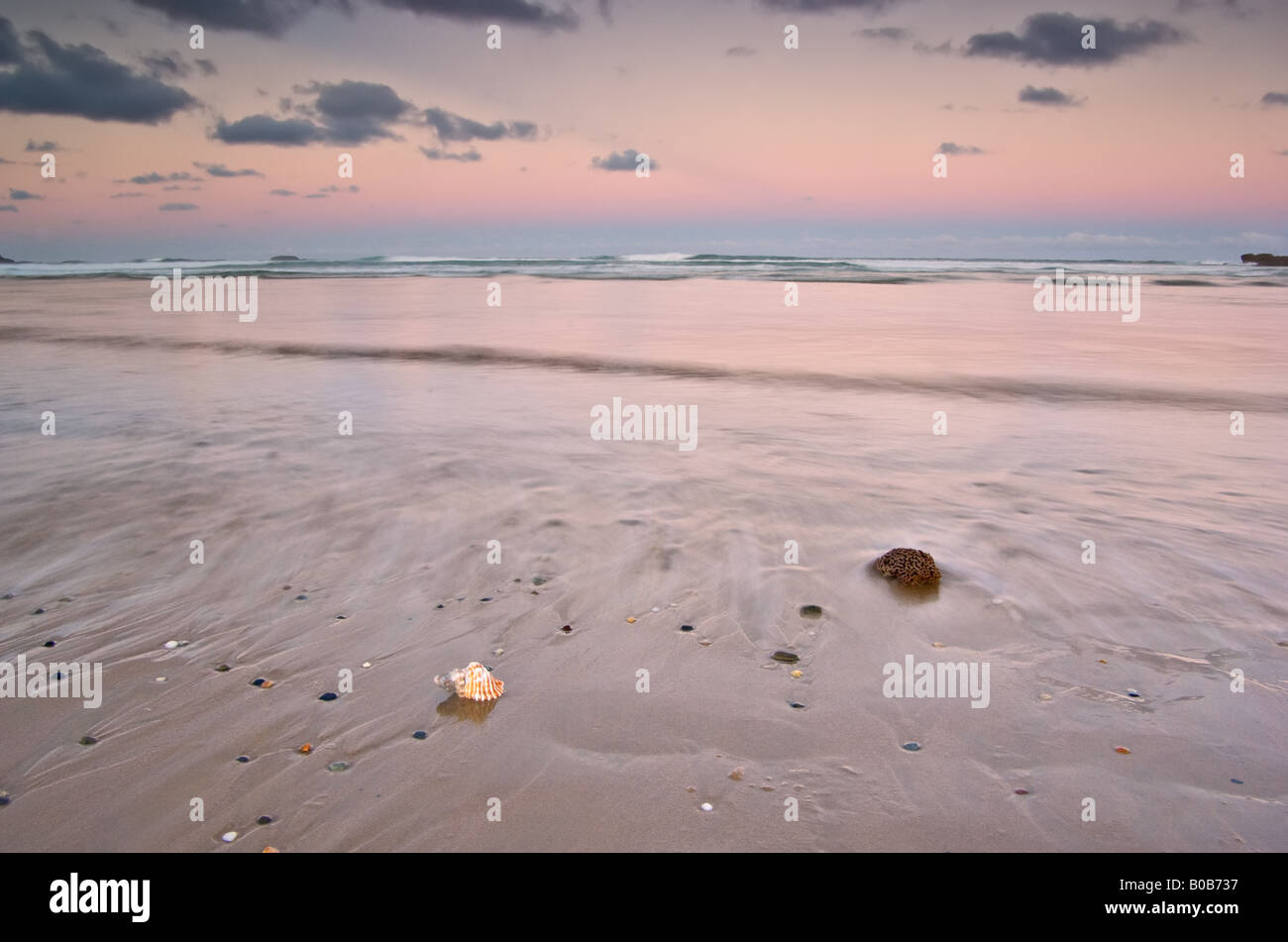 beautiful beach at sunset slow shutter for smooth water Stock Photo - Alamy