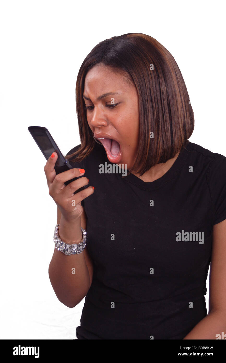 young woman screaming at mobile phone mouth open Stock Photo - Alamy