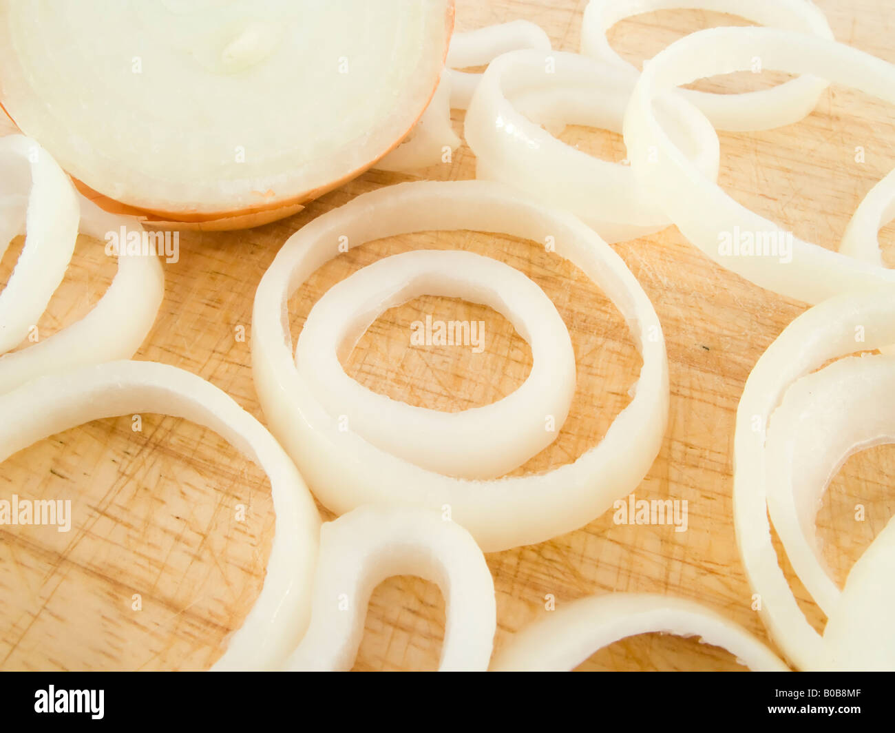 Onion rings over a kitchen wood board Stock Photo - Alamy