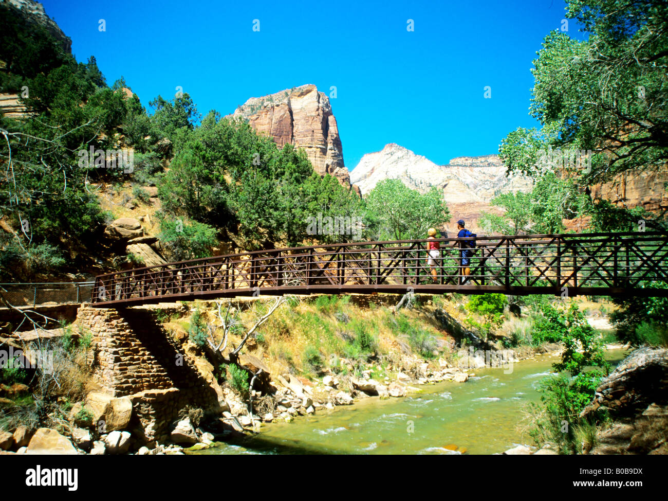 View of light metal bridge across N. Virgin river at Zion National Park ...