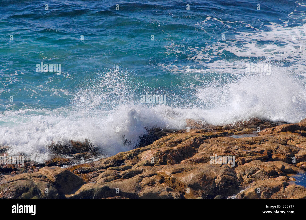 waves crashing onto this pile of rocks Stock Photo - Alamy