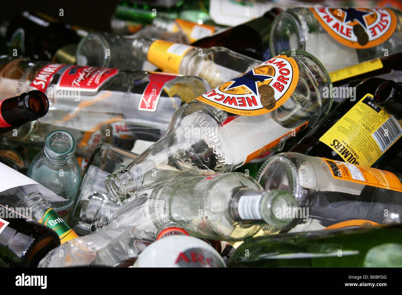 Empty soft drink and alcohol bottles in a skip for recycling outside a ...
