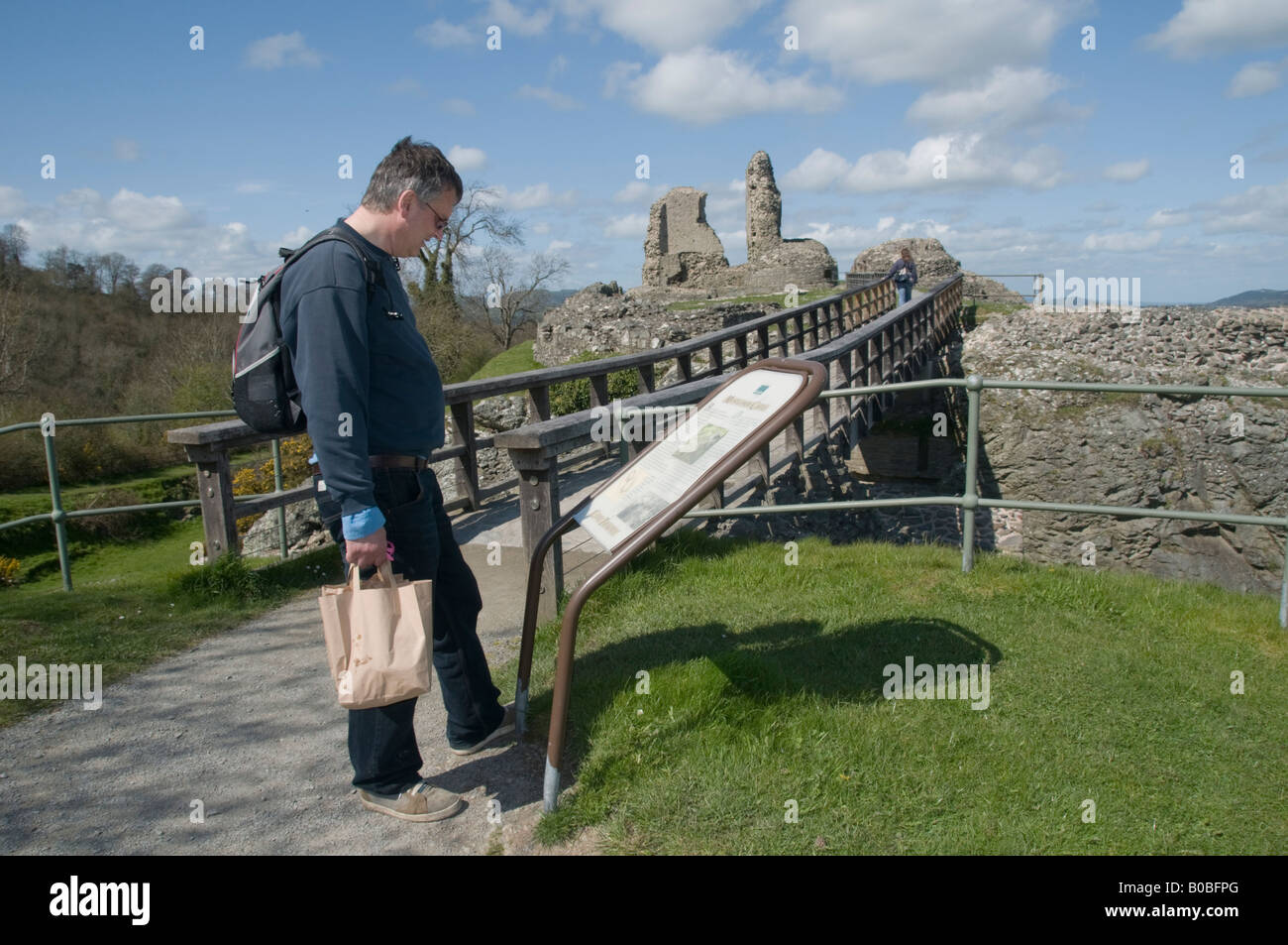 Tourist visiting the ruins of Montgomery Castle a CADW property Powys ...
