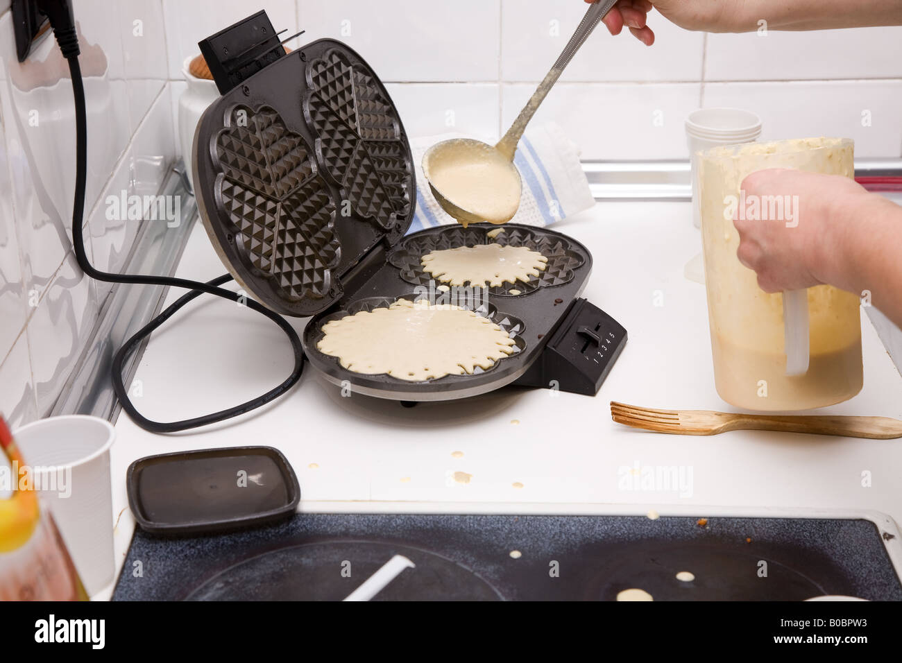Making waffles in the kitchen Stock Photo - Alamy