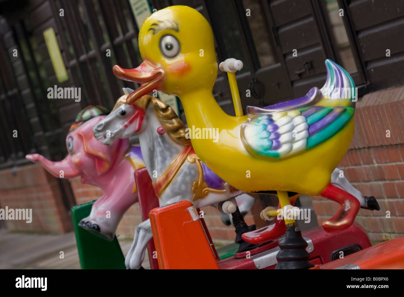 Kids playground with ride on animals Stock Photo - Alamy