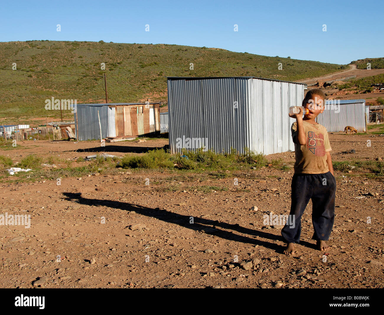 A boy, in front of a shack Stock Photo - Alamy