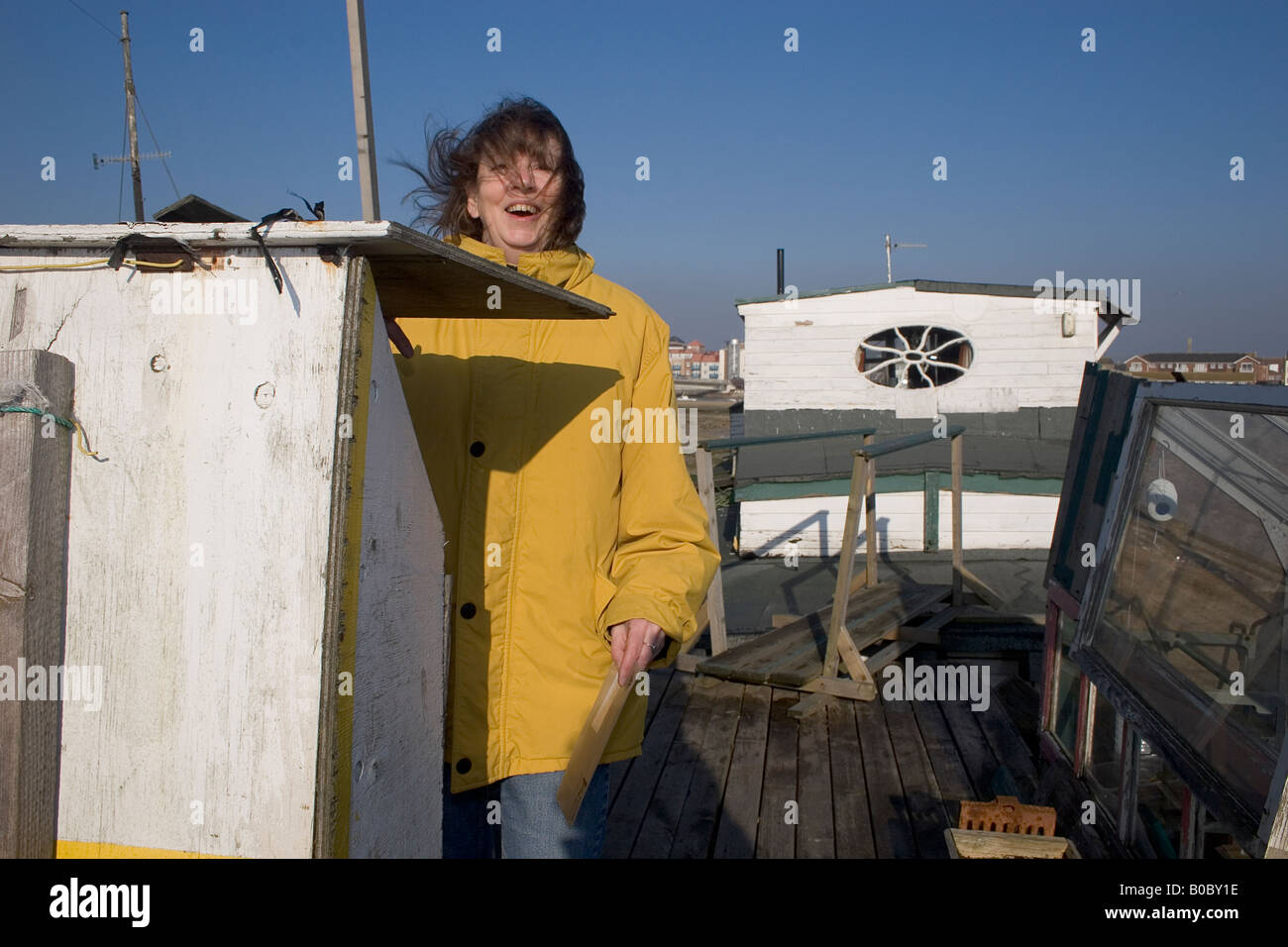 woman on houseboat wearing yellow jacket Stock Photo - Alamy