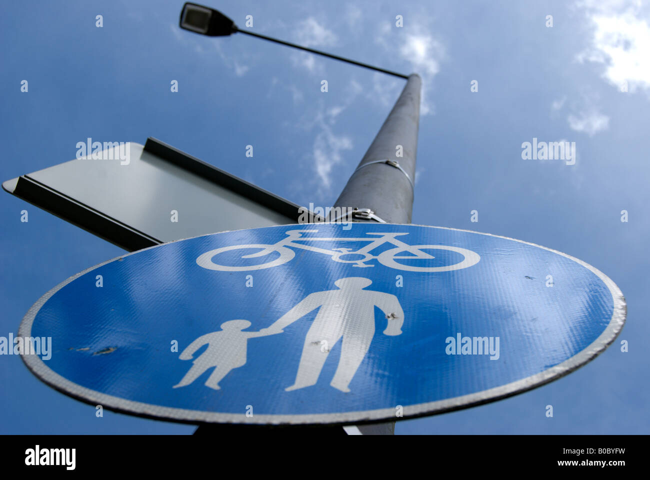 british road sign fixed to a lamppost indicating a pathway shared by ...
