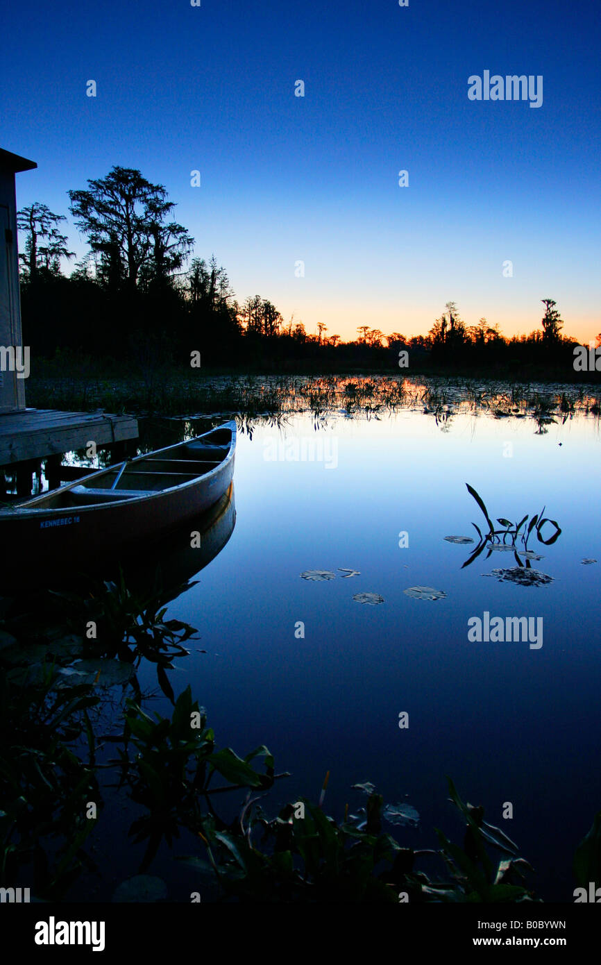 Canoe at sunrise camp in the Okefenokee National Wildlife Refuge swamp ...