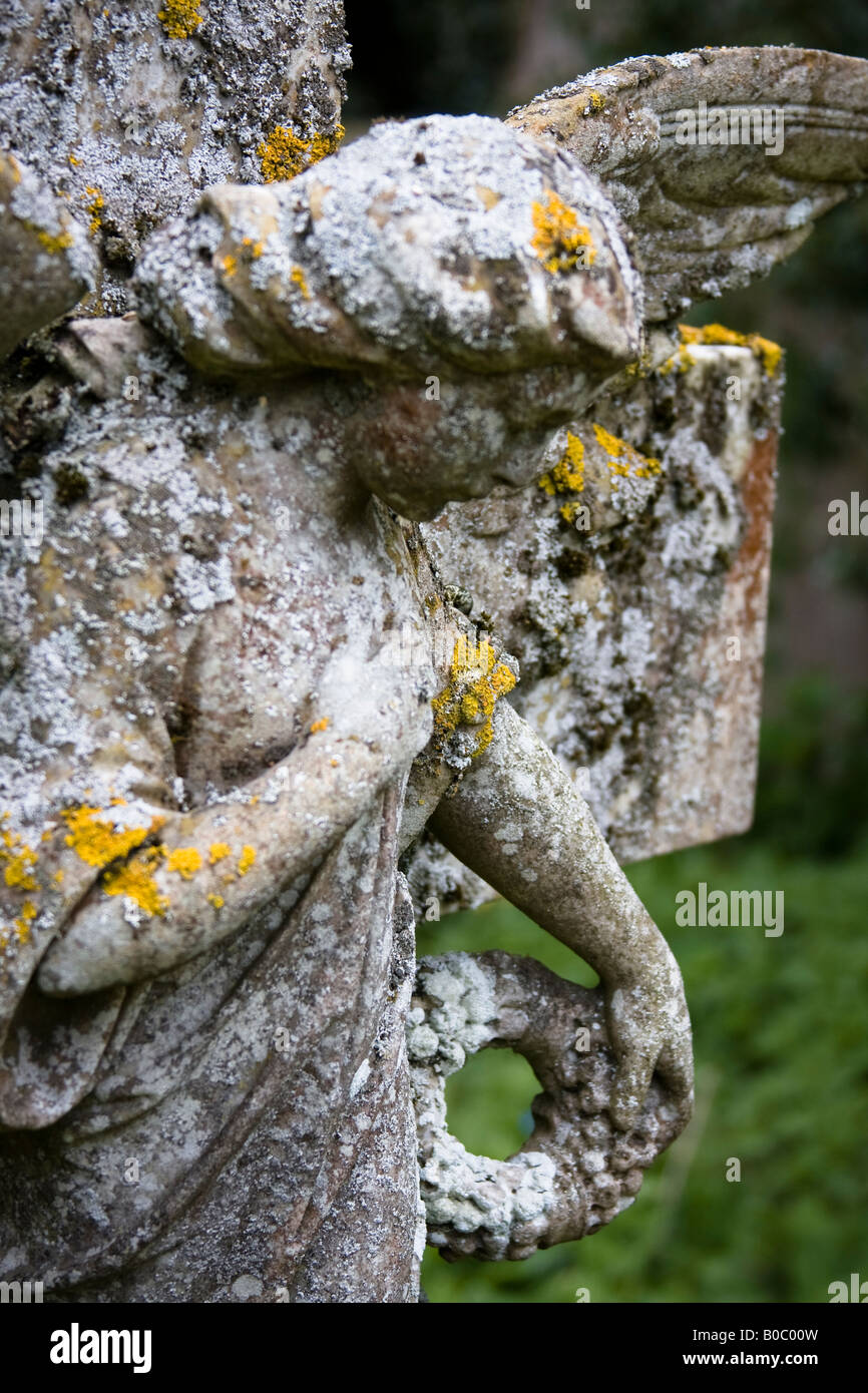 Decorated headstone cross with angel looking over grave Stock Photo - Alamy