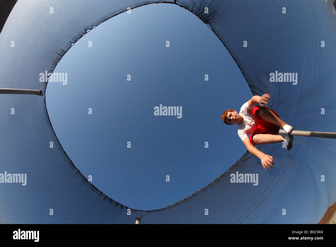 Jumping on trampoline Stock Photo - Alamy