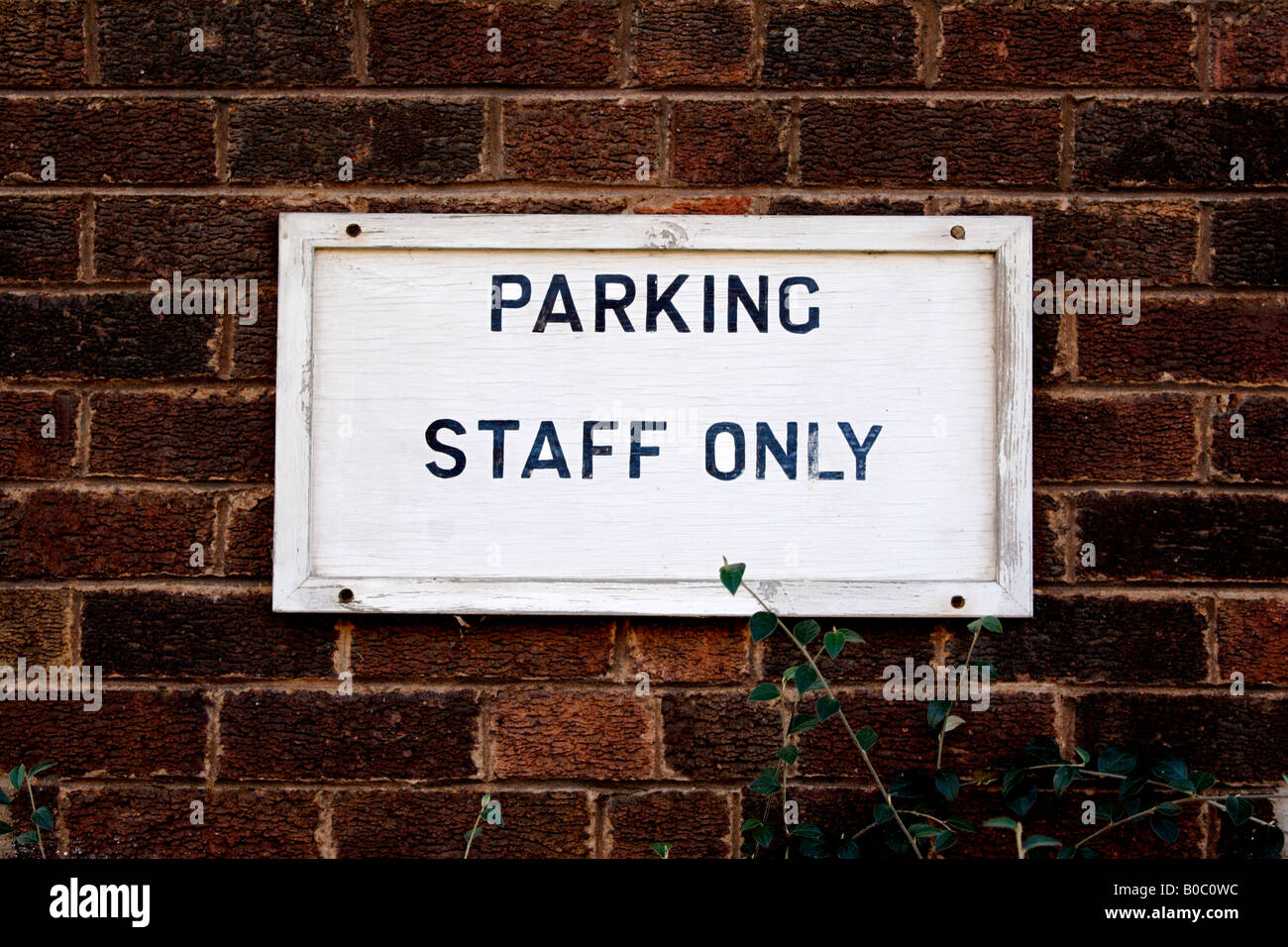 Parking for staff only sign on brick wall Stock Photo - Alamy