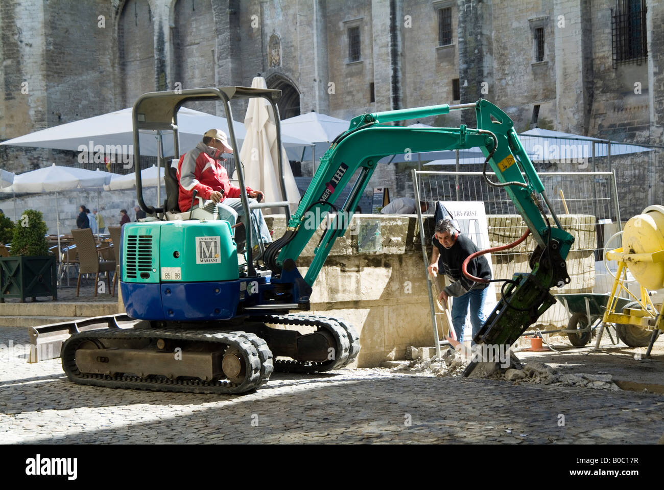 mini digger EXACAVTOR drill concrete breaker pneaumatic digging up the ...
