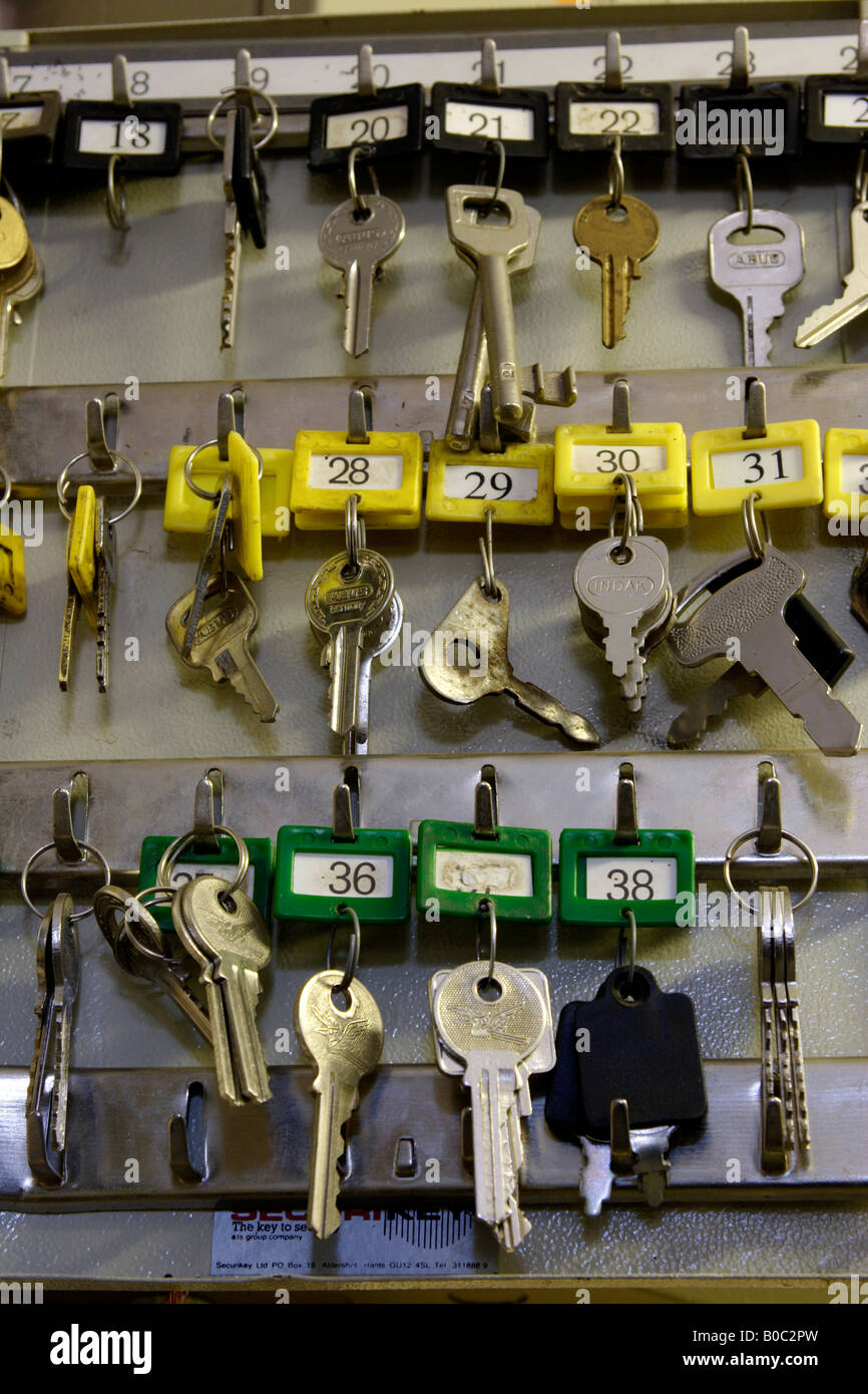 Assortment of keys hanging in industrial storage box Stock Photo - Alamy