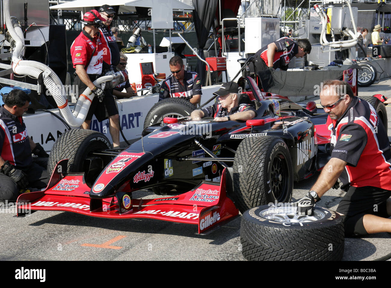 A pit crew doing testing on a race car at the Toronto Grand Prix ...